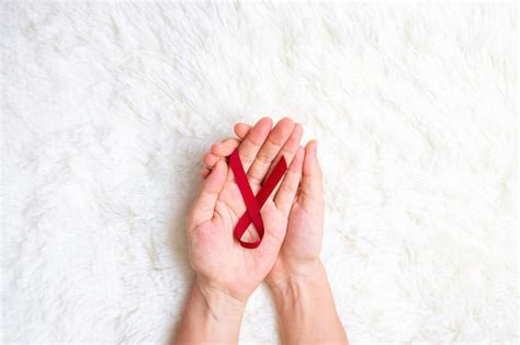Premium Photo Burgundy Red Ribbon For Supporting People Living And