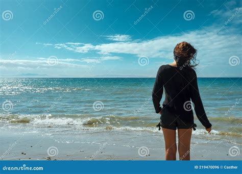 Beautiful Woman At The Seaside Enjoying The Warm Breeze Blowing Her