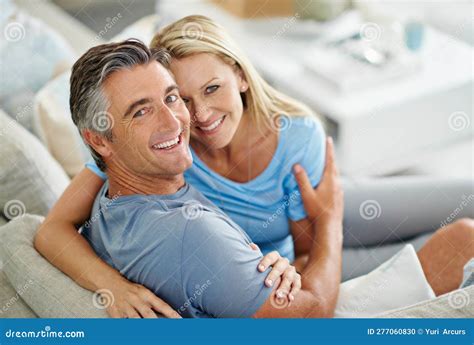 Taking Life Easy A Mature Couple Laughing While Relaxing At Home