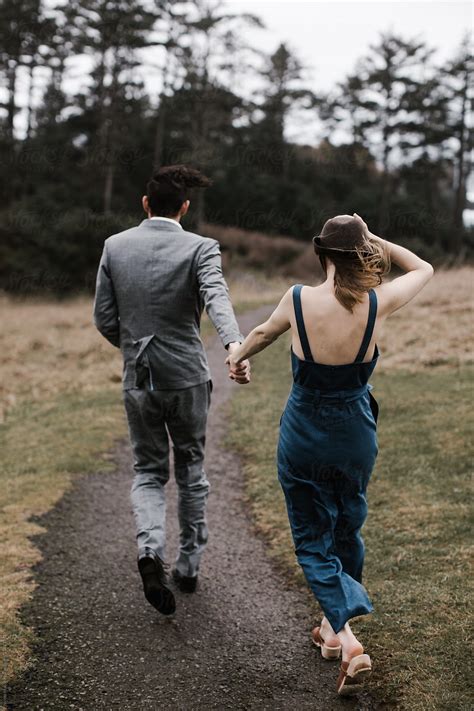 Couple Holding Hands Walking Away