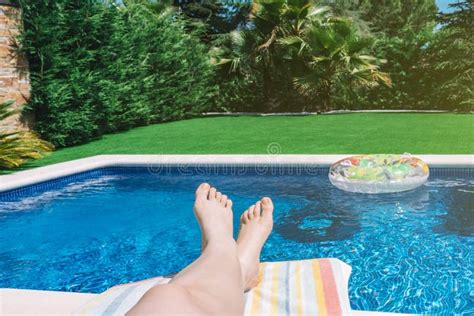 Close Up Of A Young Woman S Bare Feet On A Swimming Pool With A Float