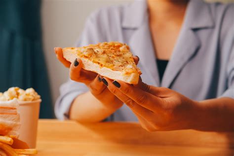 Cropped Image Of Woman Holding Pizza Slice At Restaurant 44785003 Stock