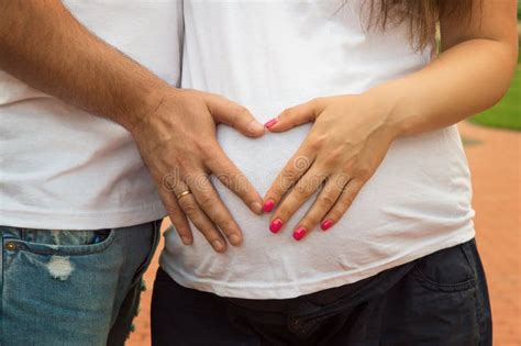 Future Father Holds His Hand On The Stomach Of His Pregnant Wife