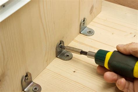 Screwing Furniture Fasteners In A Wooden Shield Stock Image Image Of
