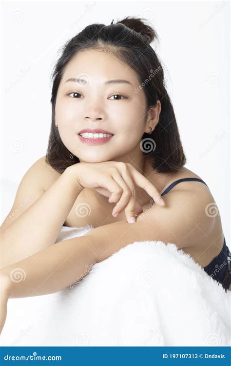 Chinese Woman Dressed In Blue Lingerie Isolated On White Background
