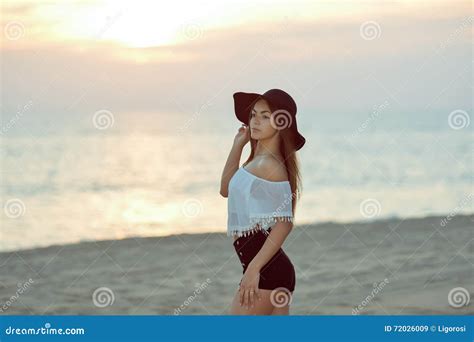 Portrait Of Beautiful Happy Woman In Hat And Shorts Enjoying Sunset