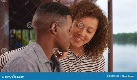 Millennial Black Man And Woman Talk Next To The Picturesque Water Stock