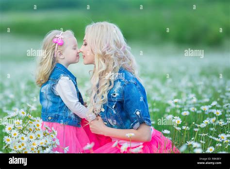Mom And Daughter On A Picnic In The Chamomile Field Two Beautiful
