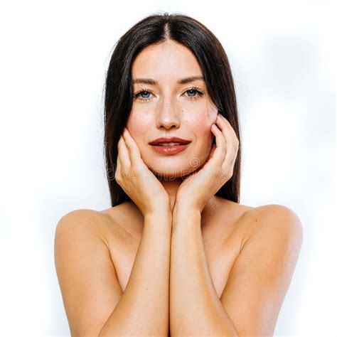 Portrait Of Beautiful Brunette Woman Model With Freckles And Blue Eyes