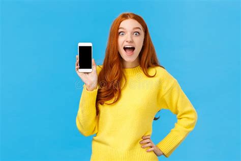 Astonished And Impressed Excited Redhead Female In Yellow Sweater