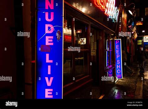Red Light District In Soho London At Night With Illuminated Signage