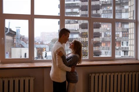 Premium Photo Young Woman And Man In Love Hug Each Other Standing