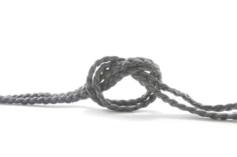 Premium Photo Close Up Of Rope Tied On Metal Against White Background