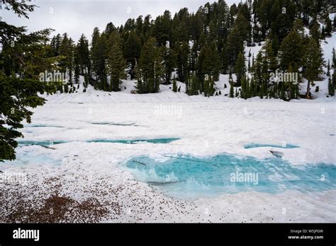 Frozen Emerald Lake In Lassen National Park With Blue Ice And Snow In