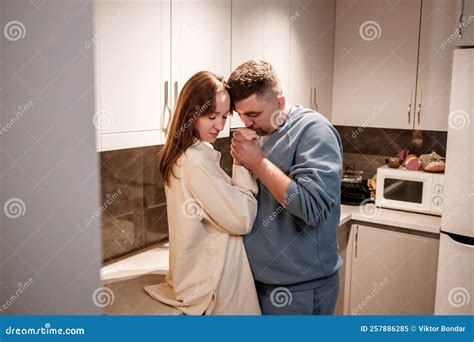 Romantic Young Couple Happily Spending Time Hugging And Kissing In Cozy