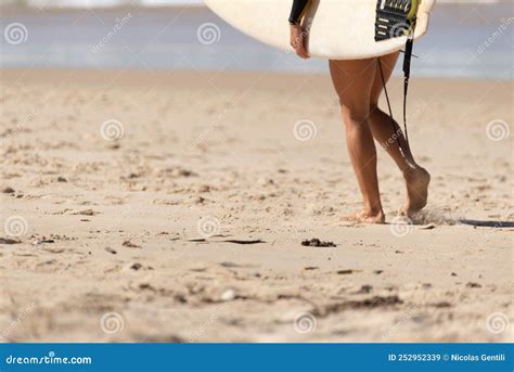 Australian Woman Surfer Walking Along The Beach Whit Her Surfboard