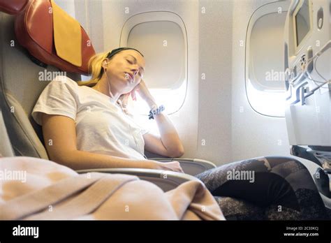Tired Blonde Casual Caucasian Lady Napping On Uncomfortable Seat While