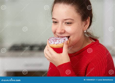 Close Up Portrait Of Young Happy Woman Eating Cake While Sitting At