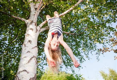 Happy Girl Hanging From A Tree In A Summer Park Stockfotos Und