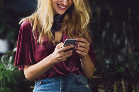 Woman Florist Holding Her Cell Phone By Stocksy Contributor Lumina