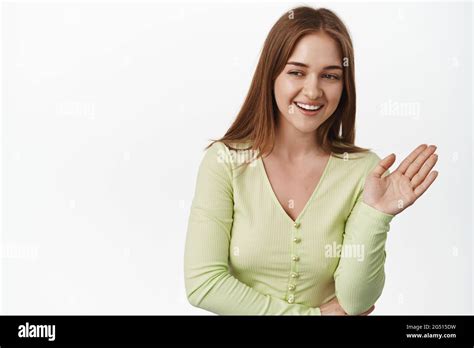 Candid Happy Woman Waving Hand Aside Looking At Friend And Wave To Say