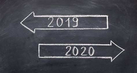two direction signs with arrows and numbers 2019 and 2020 mgh clay