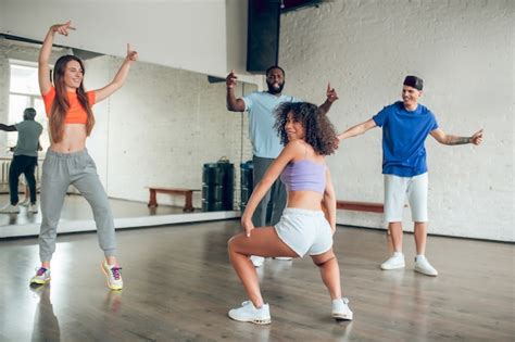 Premium Photo Dancing Group Of Energetic Cheerful Young People In