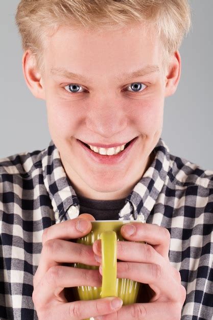 Free Photo Young Handsome Guy Holding A Cup