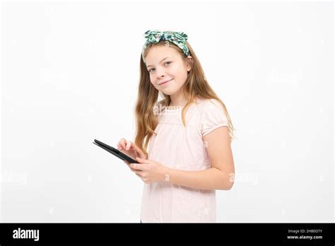 Pretty Blonde Girl With Pink Blouse And Floral Hairband Is Standing In