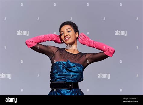 Joyful And Short Haired African American Woman With Bold Makeup Wearing