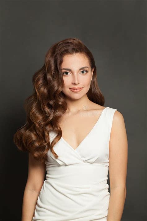 Brunette Woman With Long And Shiny Curly Hair And Natural Makeup