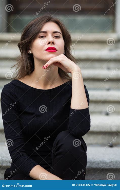 Street Portrait Of A Luxurious Woman With Red Lips And Short Hair Stock