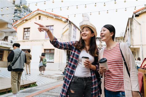 Premium Photo Cheerful Asian Girl Friends Walking At Flea Market