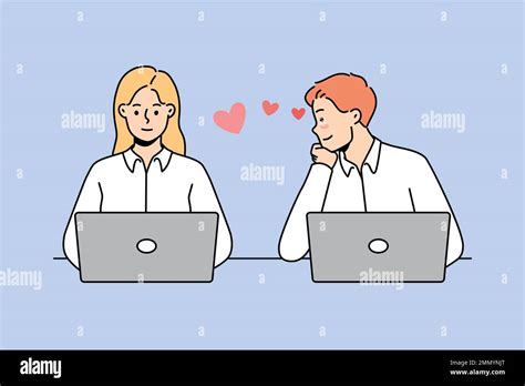 Young Man In Love Look At Female Colleague Working Together At Laptops
