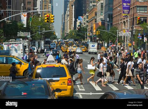 Traffic And Pedestrians On Crowded City Streets In Manhattan In New