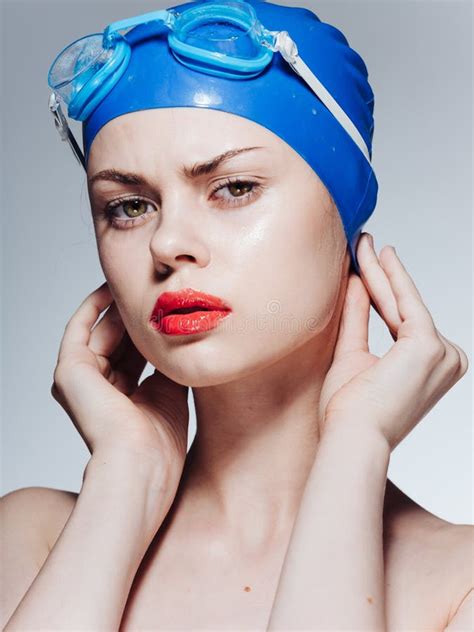 Woman In Blue Goggles Swimming Cap Naked Shoulders Light Background