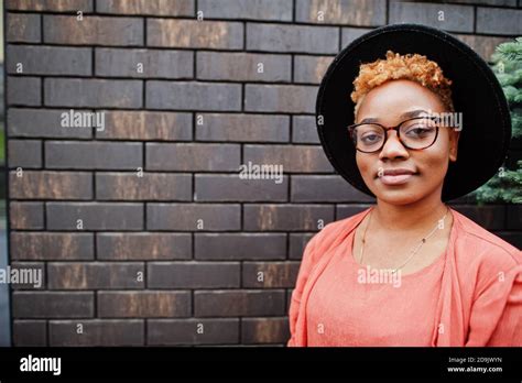 African Red Haired Woman Wear Eyeglasses Orange Dress And Black Hat