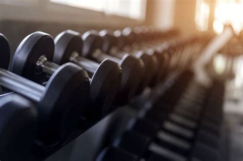 Premium Photo Blurred Background Of Rows Of Black Dumbbells On Rack