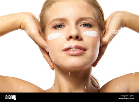Portrait Of Young Woman Applying Moisturizer Cream On Clean Fresh Face