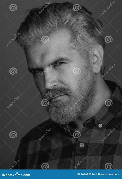 Mature Blonde Bearded Guy With Trendy Hairdo In Casual Shirt Smiling