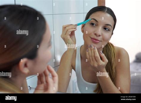 Facial Hair Removal Close Up Of Beautiful Young Woman Shaving Her Face