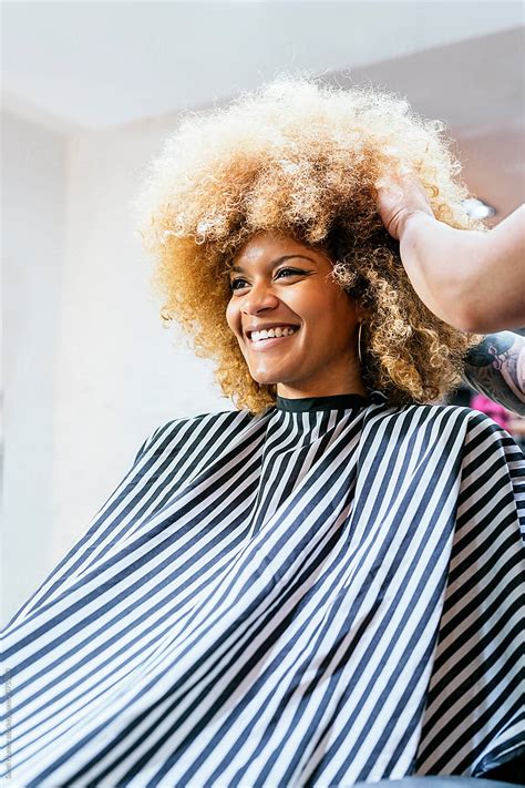 Beautiful Afro Woman Getting Haircut By Hairdresser In The Beauty