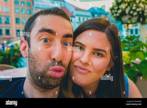 Happy Young Couple Taking A Selfie With A Smartphone Or Camera In The