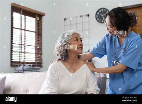 Young Caregiver Helping Senior Woman Nurse Assisting Her Old Woman