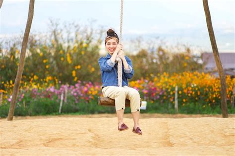 Premium Photo Full Length Portrait Of Woman Sitting On Swing