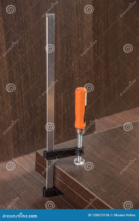 Assembling A Wooden Cabinet At Home Using A Drill And A Screwdriver