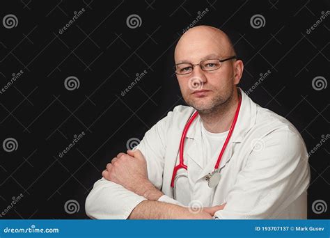 Portrait Of A Bald Doctor In White Uniform And Red Stethoscope On A