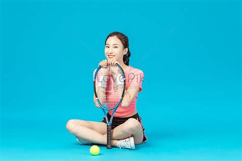 Girl Sitting On The Floor Holding A Tennis Racket Picture And Hd Photos