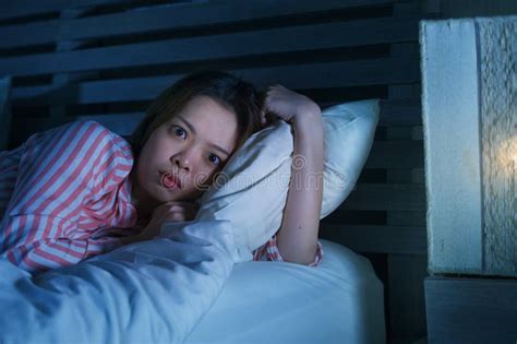 Young Beautiful Asian Chinese Girl Lying On Bed Late Night Awake
