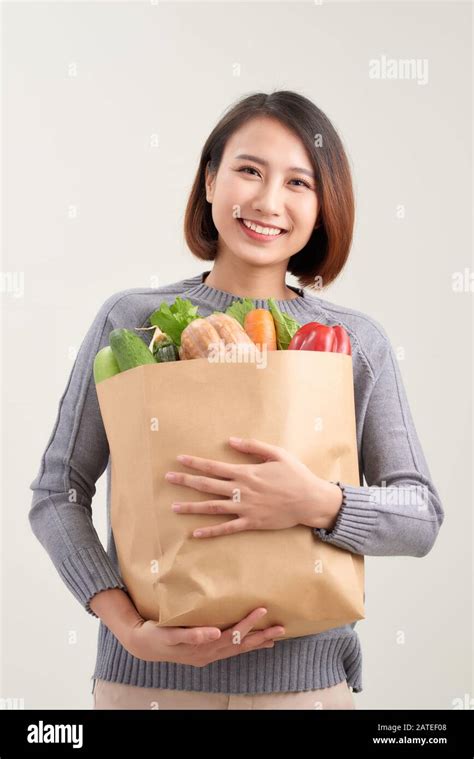 Beautiful Smiling Asian Woman Holding Paper Shopping Bag Full Of